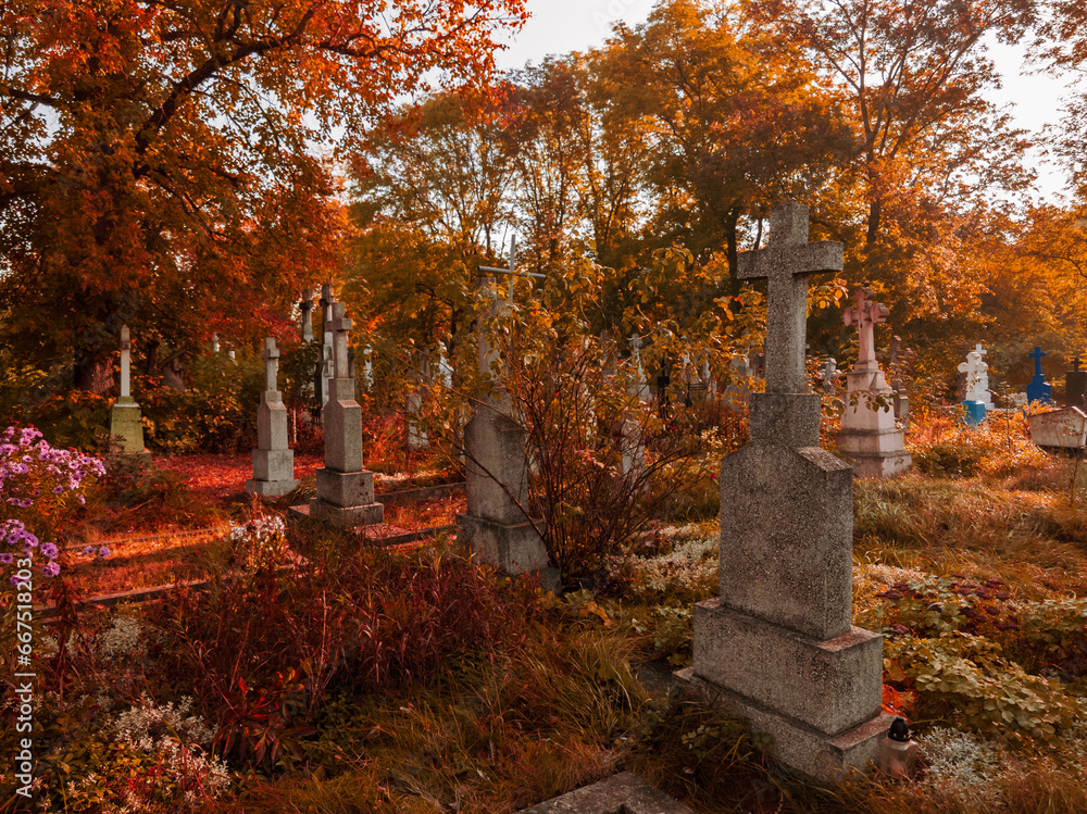 Atmospheric autumn cemetery in the sunlight. Stone crosses and graves ...