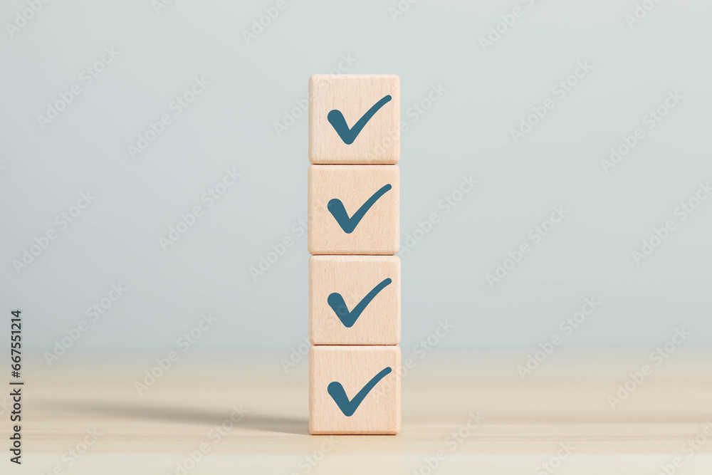 Wooden blocks display checkmarks to summarize task details and compile ...