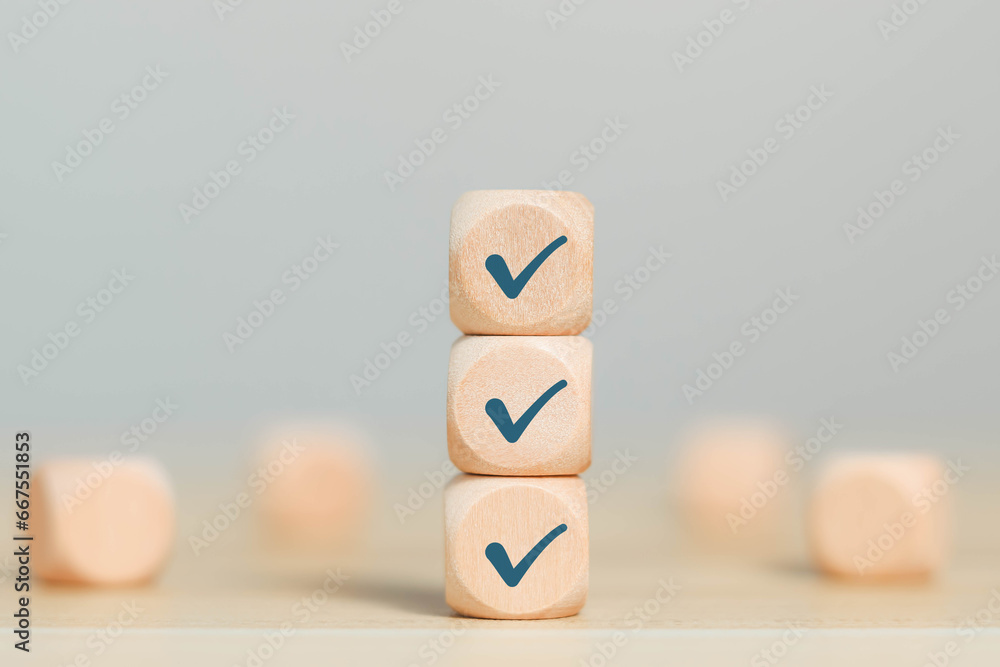 Wooden blocks display checkmarks to summarize task details and compile ...