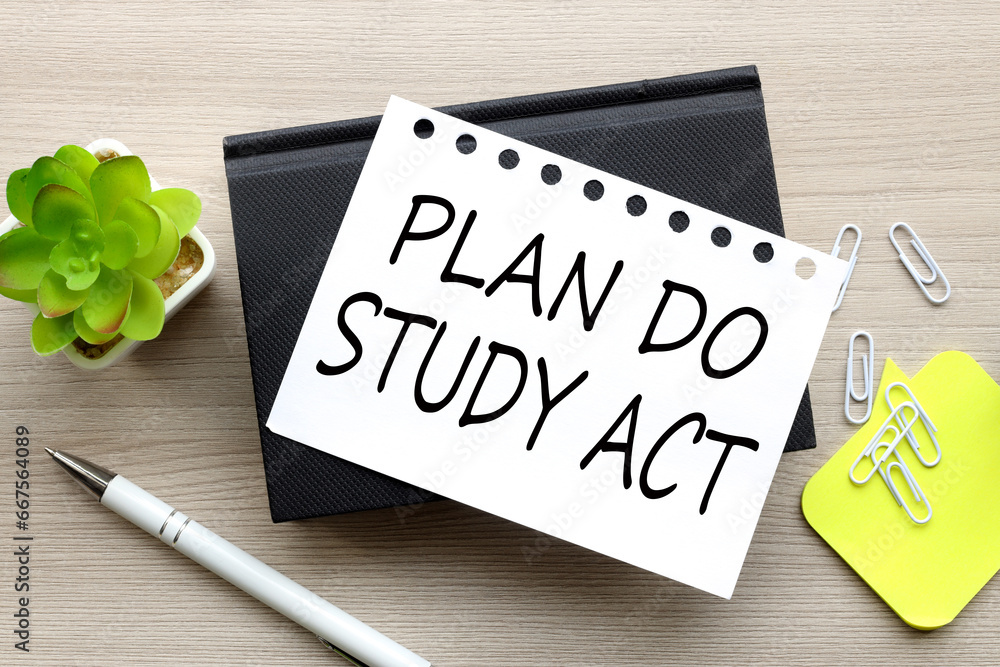 PDSA - Plan Do Study Act ,on a white page on a black notepad Stock ...