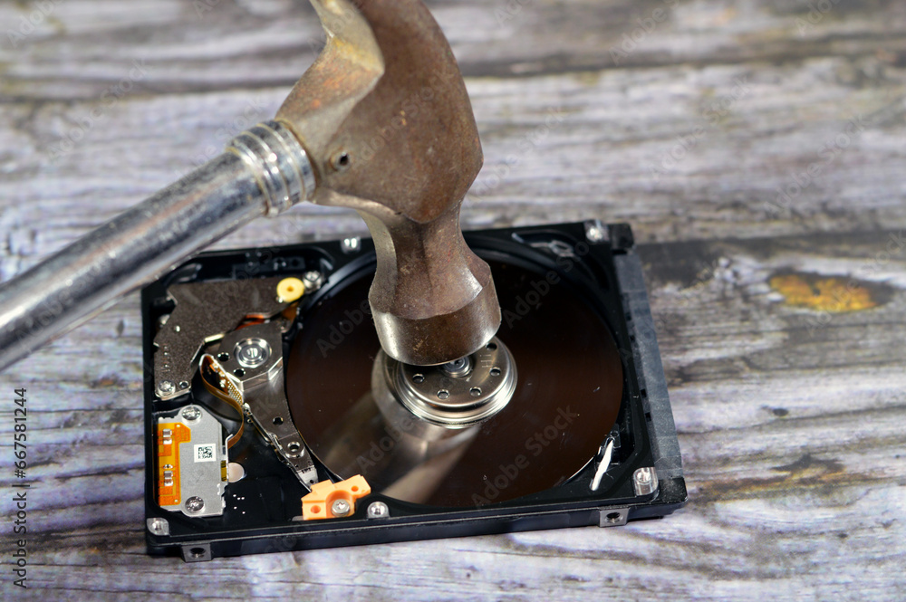 A Hammer on a laptop 2.5 inch hard disk drive storage memory, repair ...