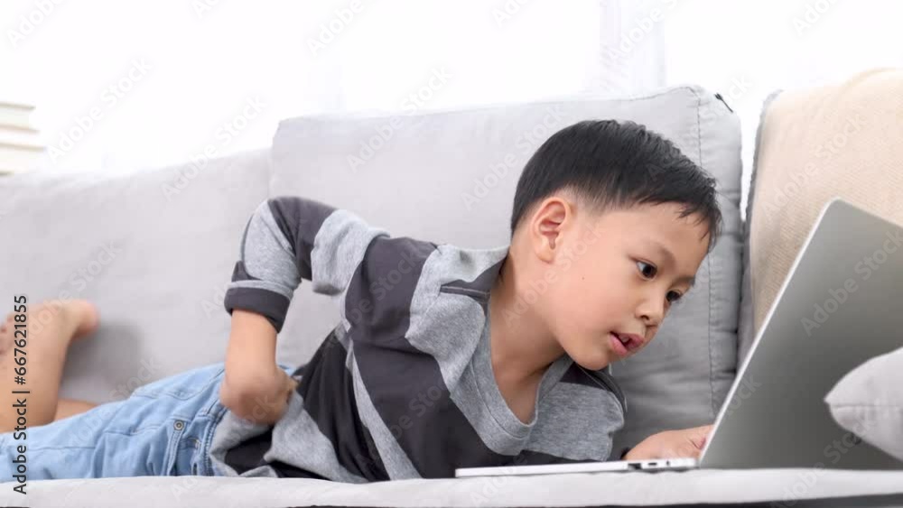 Asian little boy addicted to modern technology laptop connected to ...