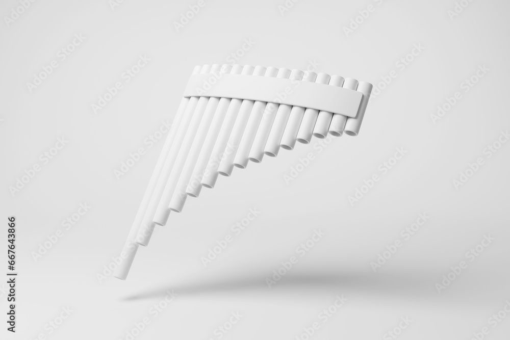 White pan flute (aka. panpipes) floating in mid air on white background ...