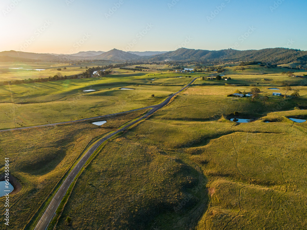 Rural road through green paddocks of Melville in Maitland area of ...