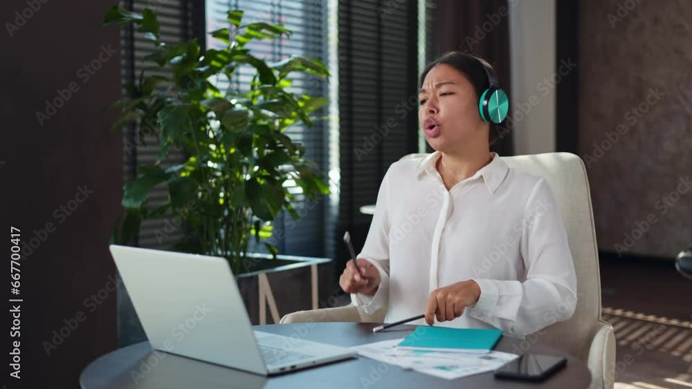 Energetic female company worker in wireless headphones imagining ...