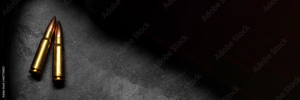 Poster Two bullets for Kalashnikov assault rifle on gray concrete and ...