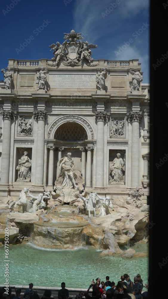 Vertical tracking shot of Trevi water fountain and sculpture building ...