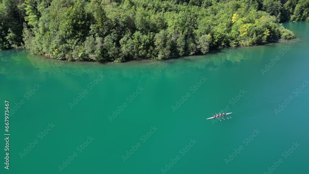 group team of people coordinating riding thin tiny kayak with paddles ...