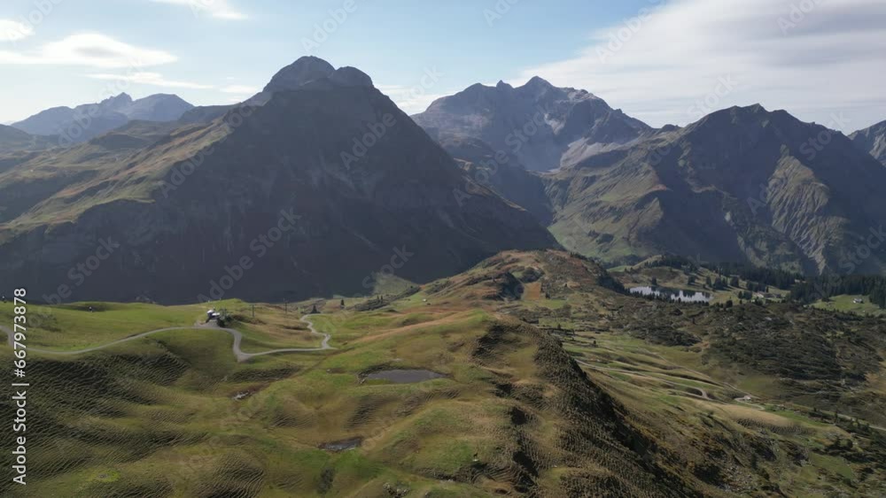 A breathtaking aerial view of green hills and a winding road in the ...