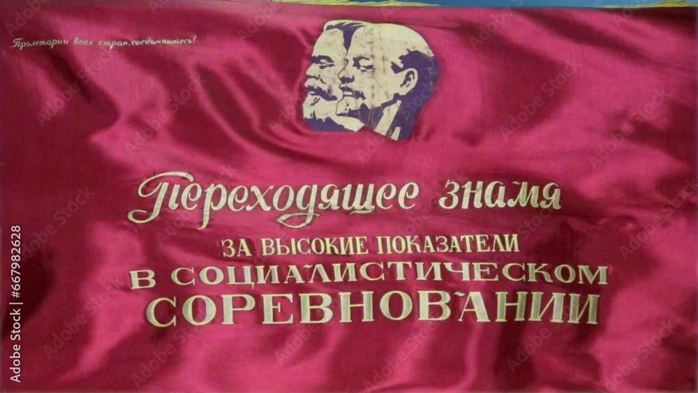 Soviet propaganda flag flies in slow motion. Slogans read ...