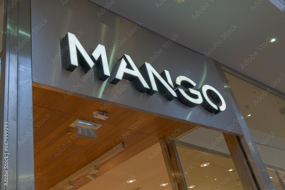 Mango chain logo text and brand sign of Spanish clothes store wall shop ...