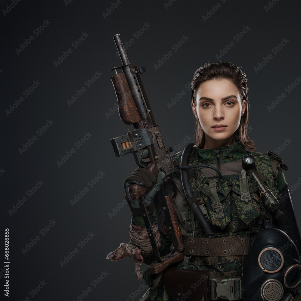 Portrait of a female soldier in military attire, holding a homemade ...