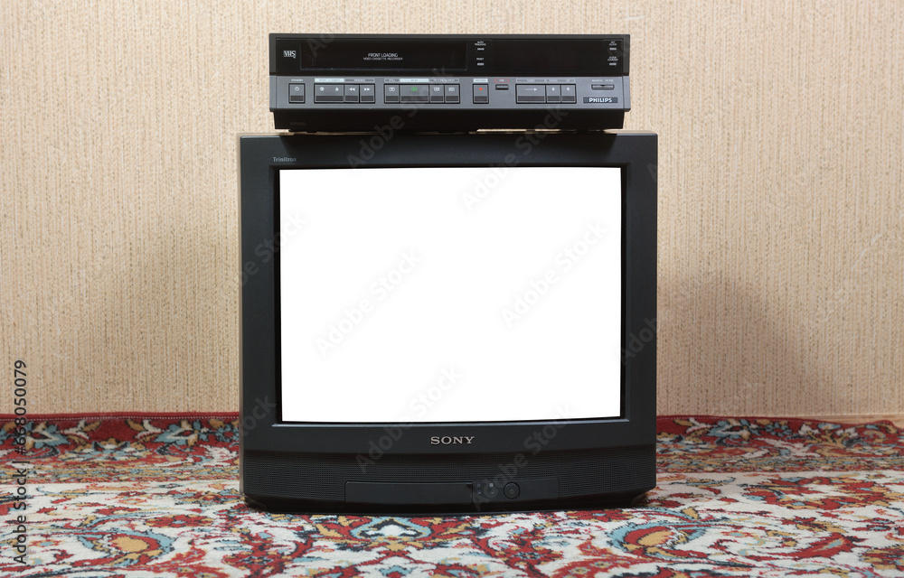 An old Sony Trinitron TV with a white screen and a Philips VCR on the ...