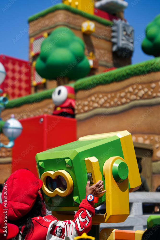 Japan - April 03, 2023: Tourist woman use binocular for looking at ...