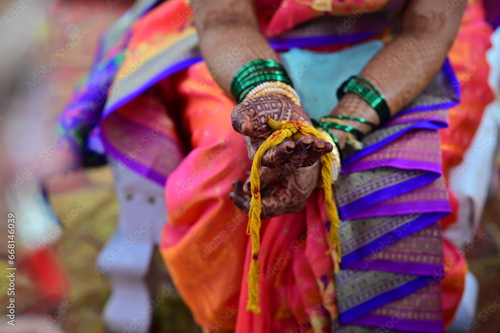 Yellow Turmeric Thread on hand of bride. Hands of bride holding yellow ...