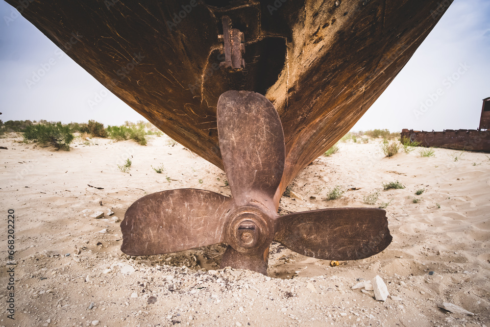 Rusty ships and boats in the desert at the bottom of the dried up Aral ...