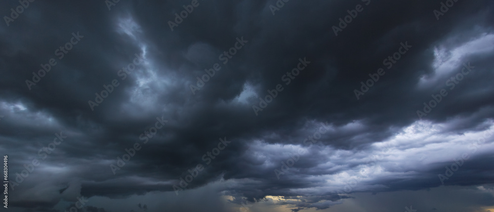 The dark sky with heavy clouds converging and a violent storm before ...