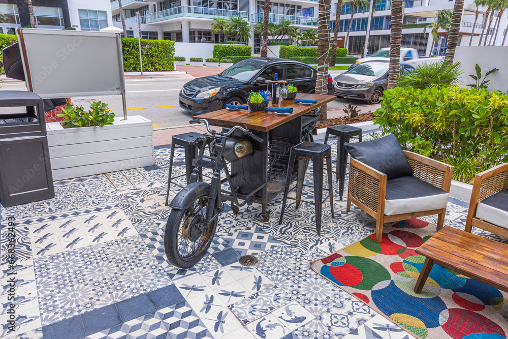 Beautiful view at motorcycle-shaped table in street-side tavern ...