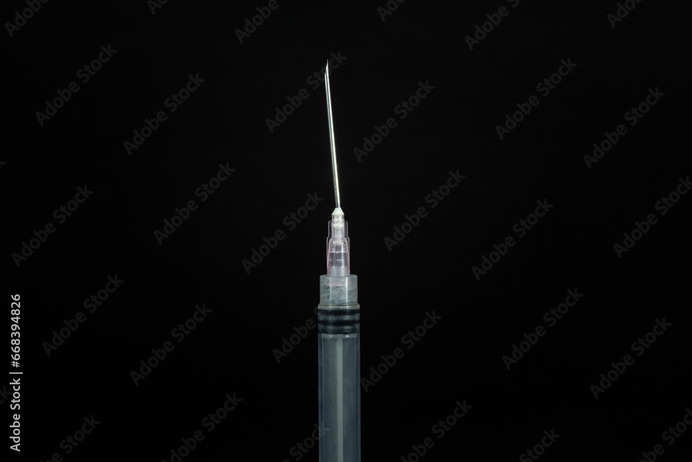 Selective blur on the tip and top of a syringe, medical syringe with a ...