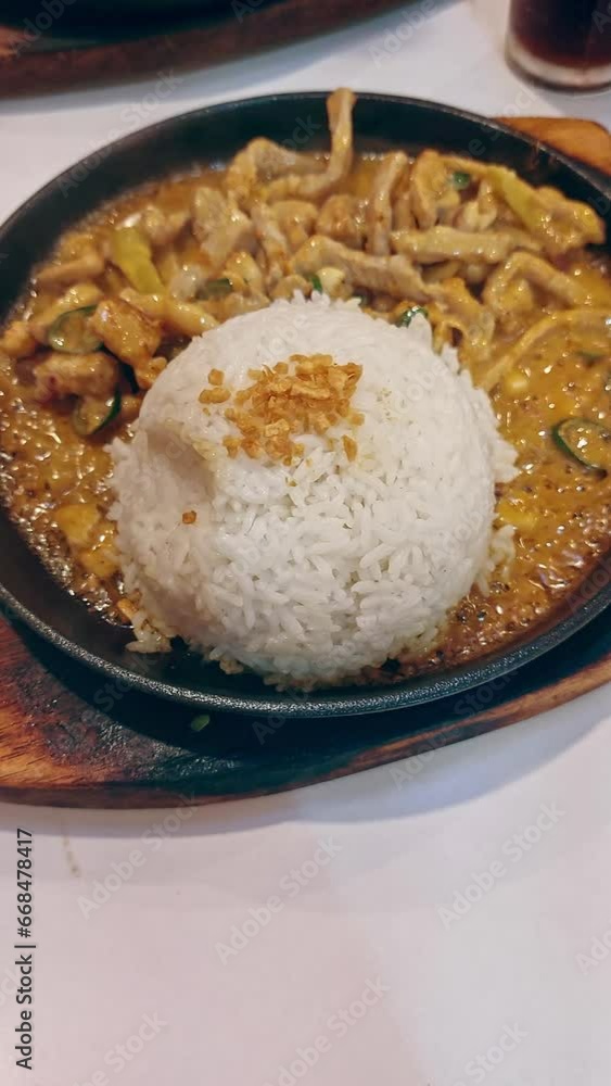 Top view of Bicol express served in a sizzling hot plate known natively ...