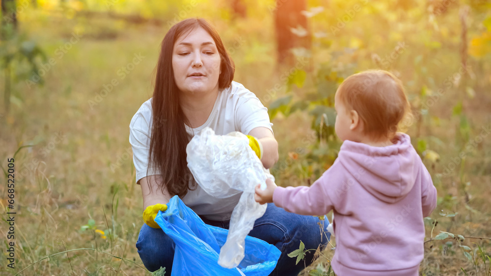 Toddler girl contributes to environmental conservation by helping mom ...
