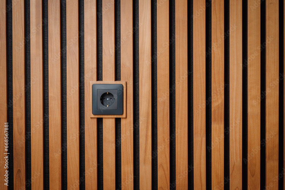 Black outlet plug on the wooden wall. Socket and European Power in the ...