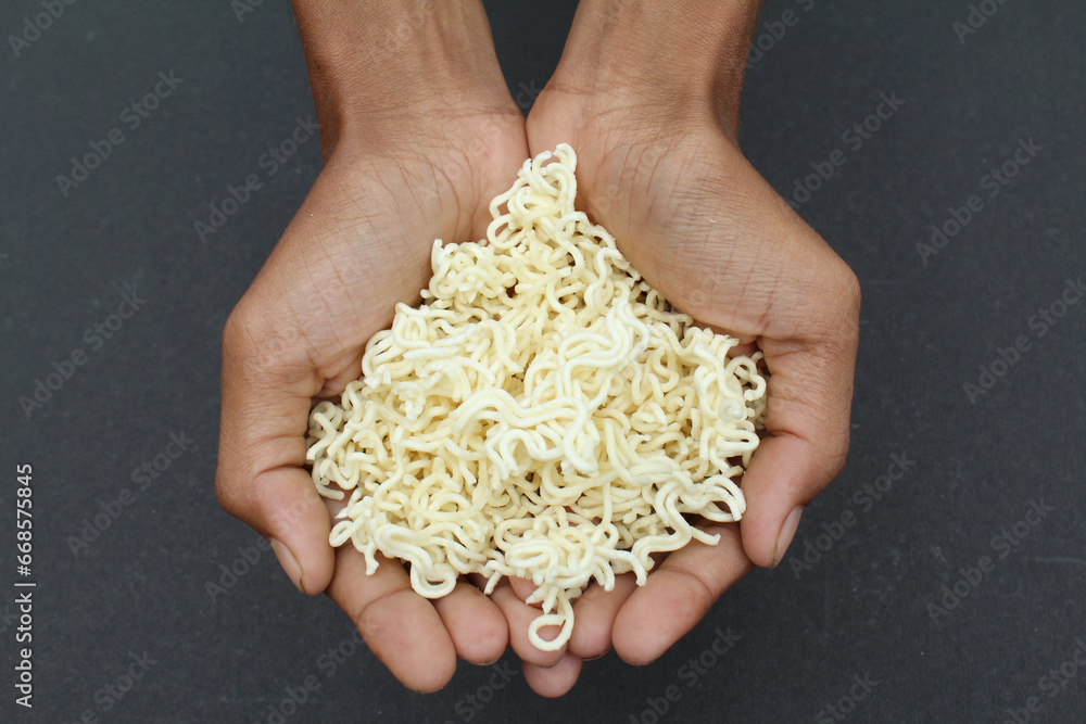 Holding some uncooked broken noodles in a hand top view Stock Photo ...