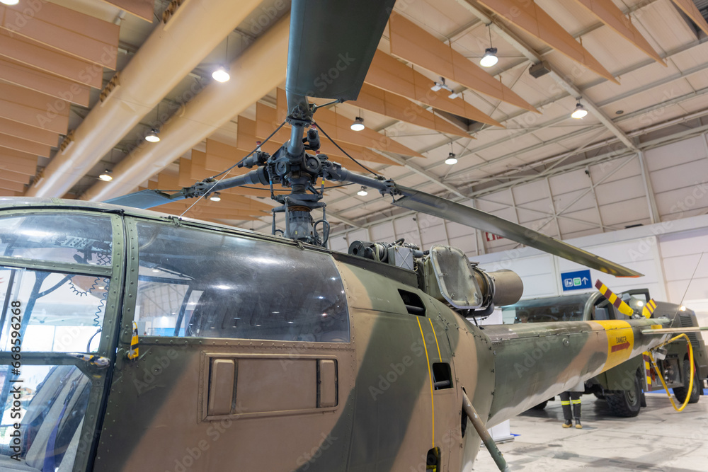 Military helicopter stand inside big pavilion Stock Photo | Adobe Stock