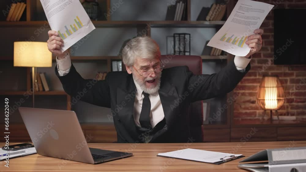 Happy older man in formal suit holding paper records high in air while ...
