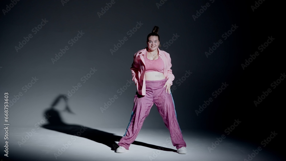 Attractive woman dancing jazz-funk in a studio. Black to white soft ...