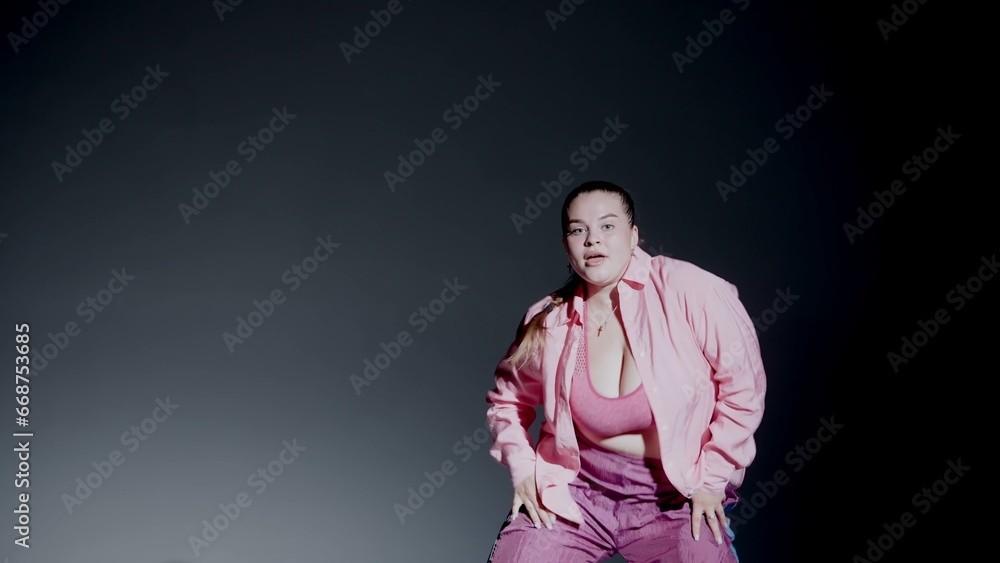 Attractive woman dancing jazz-funk in a studio. Black to white soft ...