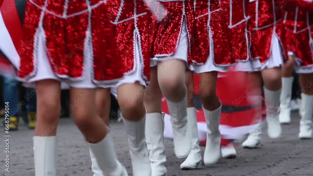 Close up legs, teen cheerleaders with red bright dress and white boots ...