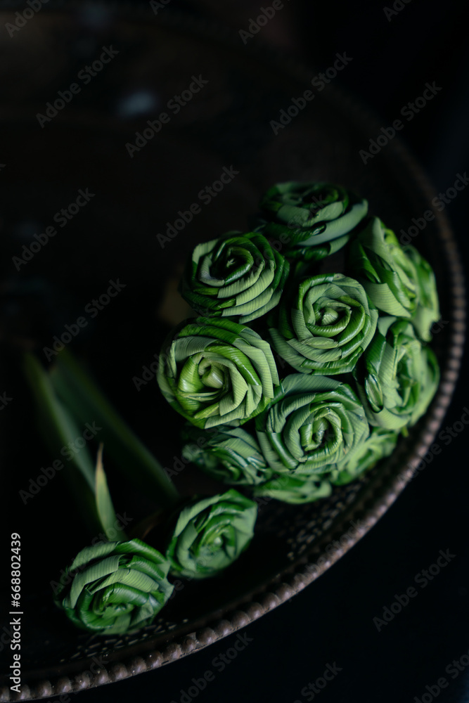 Green flowers that are folded using pandan leaves to worship the gods ...