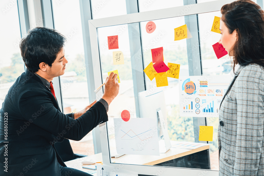 Business people work on project planning board in office and having ...