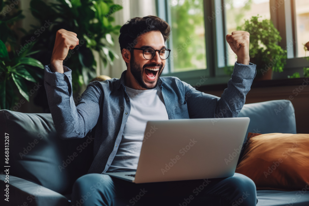 Handsome young arab man smiling and rejoicing after success. Happy man celebrating business ...