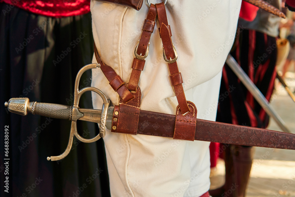 Old classical sword hanging from the belt of a war soldier costume ...