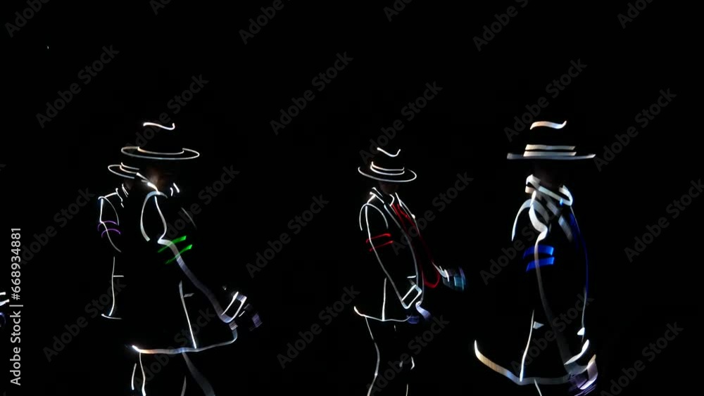 Light LED dance show. dancers in costumes with LED strip dancing in a ...
