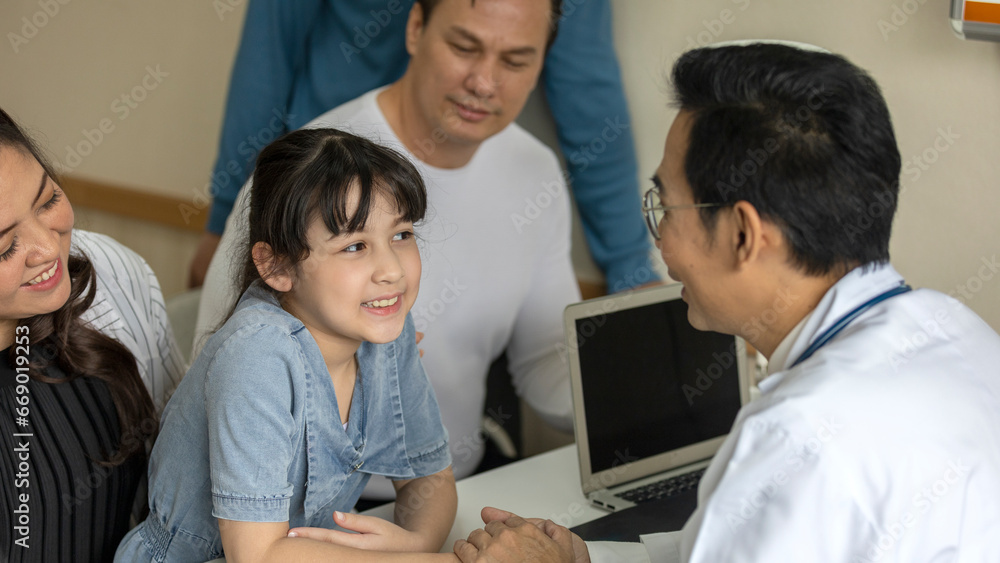 A girl gets good care from a male doctor by holding his hand with ...