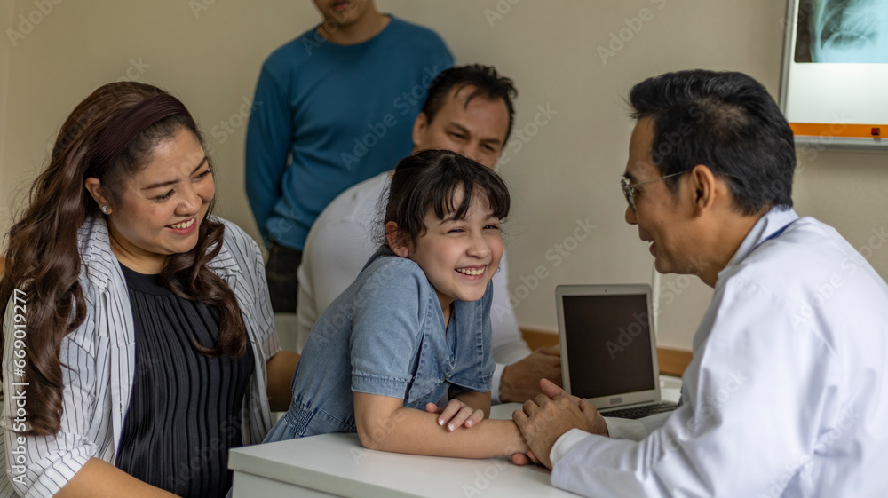 A girl gets good care from a male doctor by holding his hand with ...