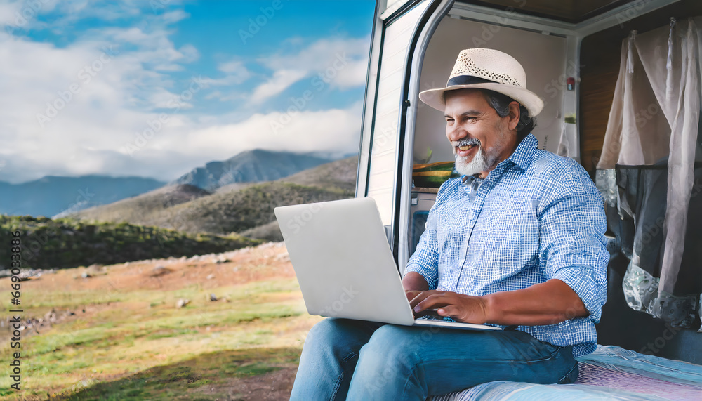 Happy older man sitting in rv camper van using laptop. Smiling mature ...