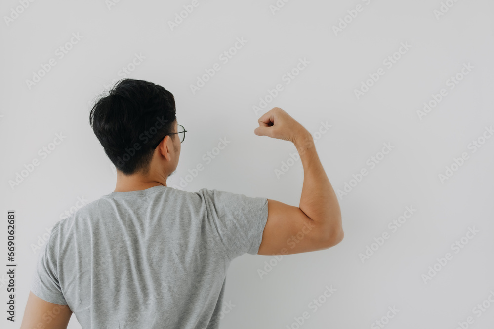 Backside view of Asian man back wear grey t-shirt raising arms, showing ...