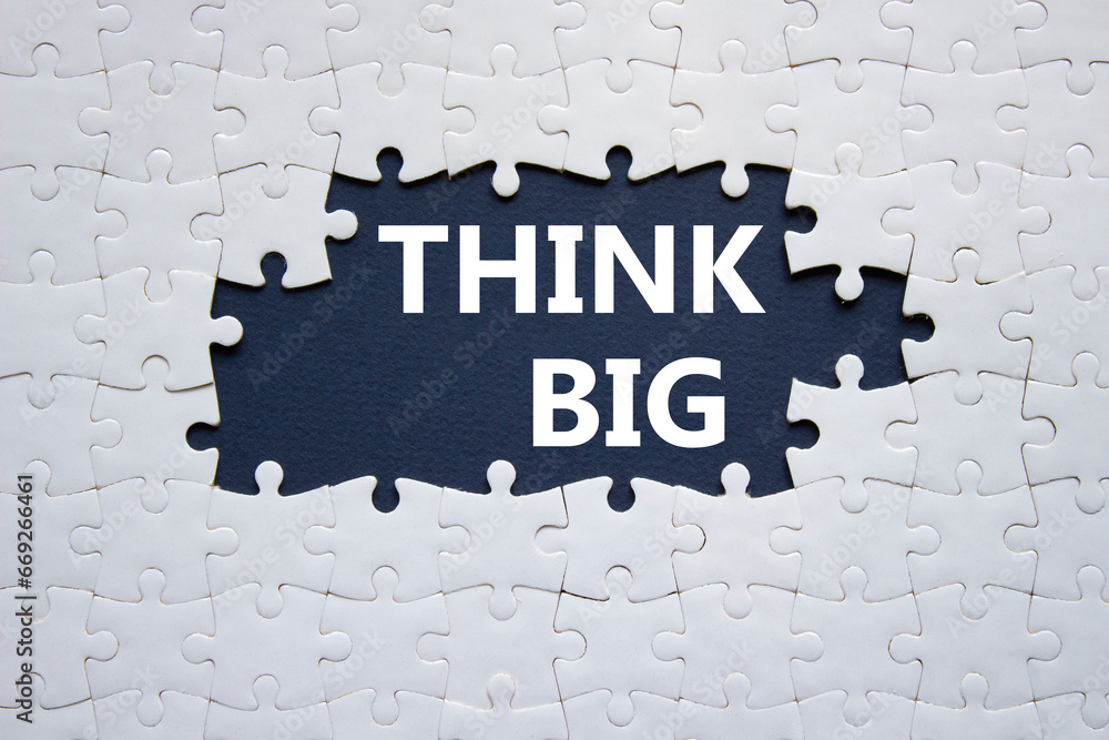 Think big symbol. White puzzle with words Think big. Beautiful dark ...
