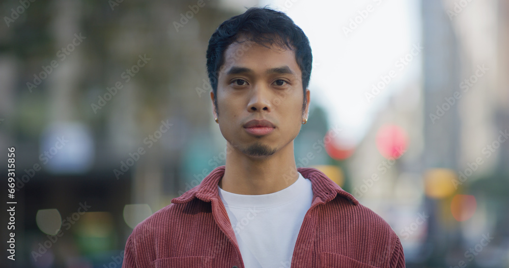 Young Filipino man serious face portrait on city street Stock Photo ...