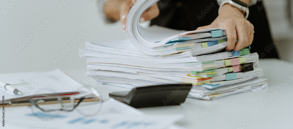Businessman man working in stacks of papers searching for unfinished ...