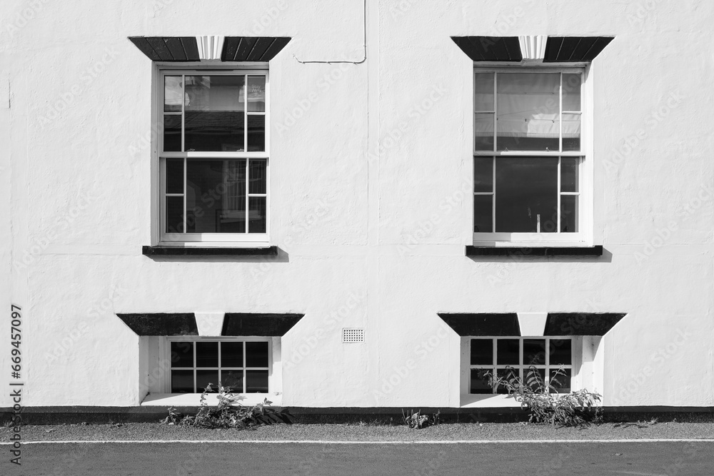 Monochrome view of an old English seaside town house showing gar large ...