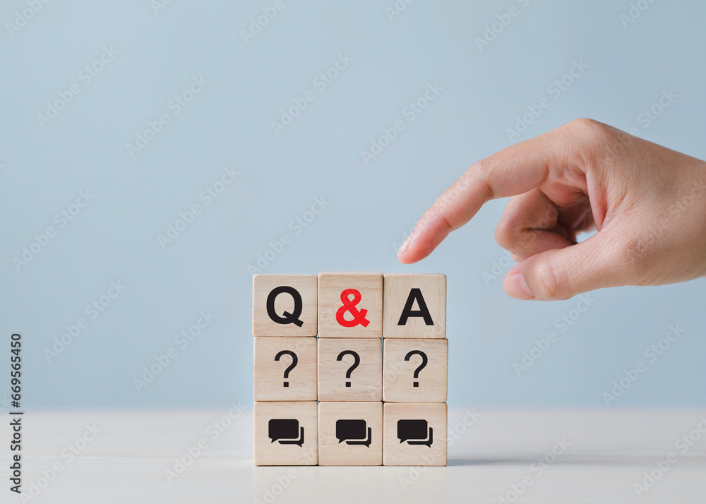 Question and answer concept. Q and A symbols on wooden blocks and hand ...