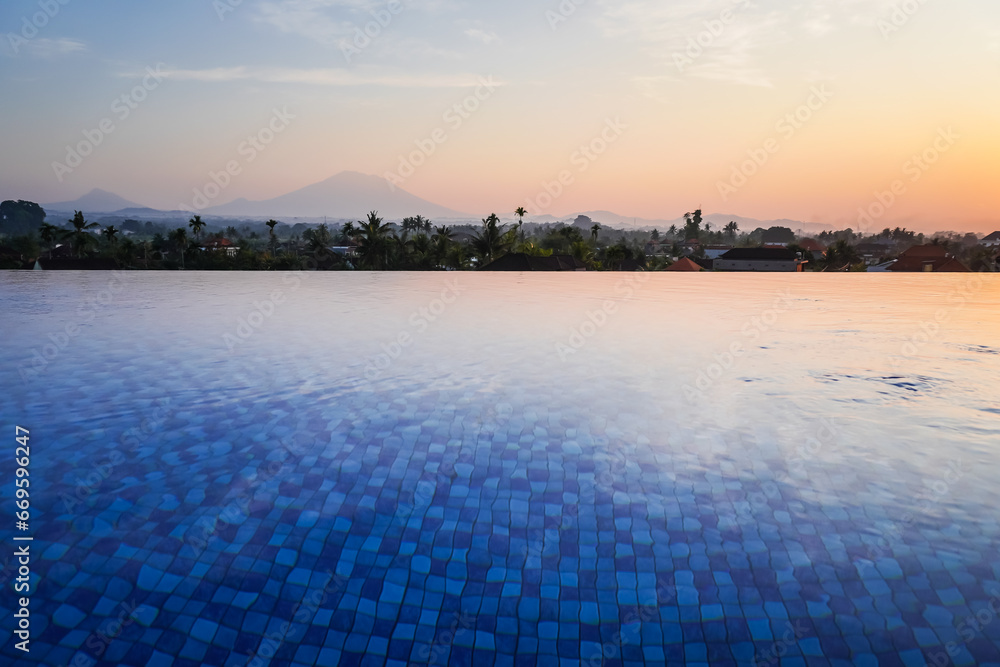 Blue swimming pool in hotel rooftop with beautiful mountain and rice ...