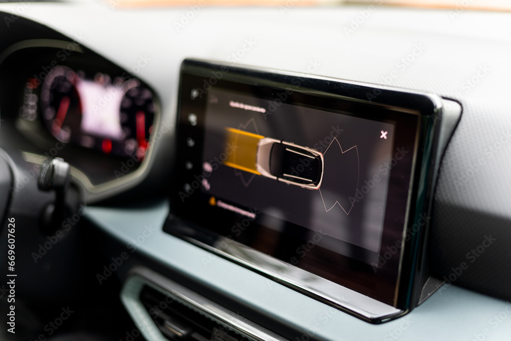 A car display inserted into the dashboard shows the alignment of the ...