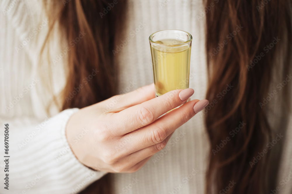 Girl holding vodka shot. Woman drinking vodka background. Homemade ...