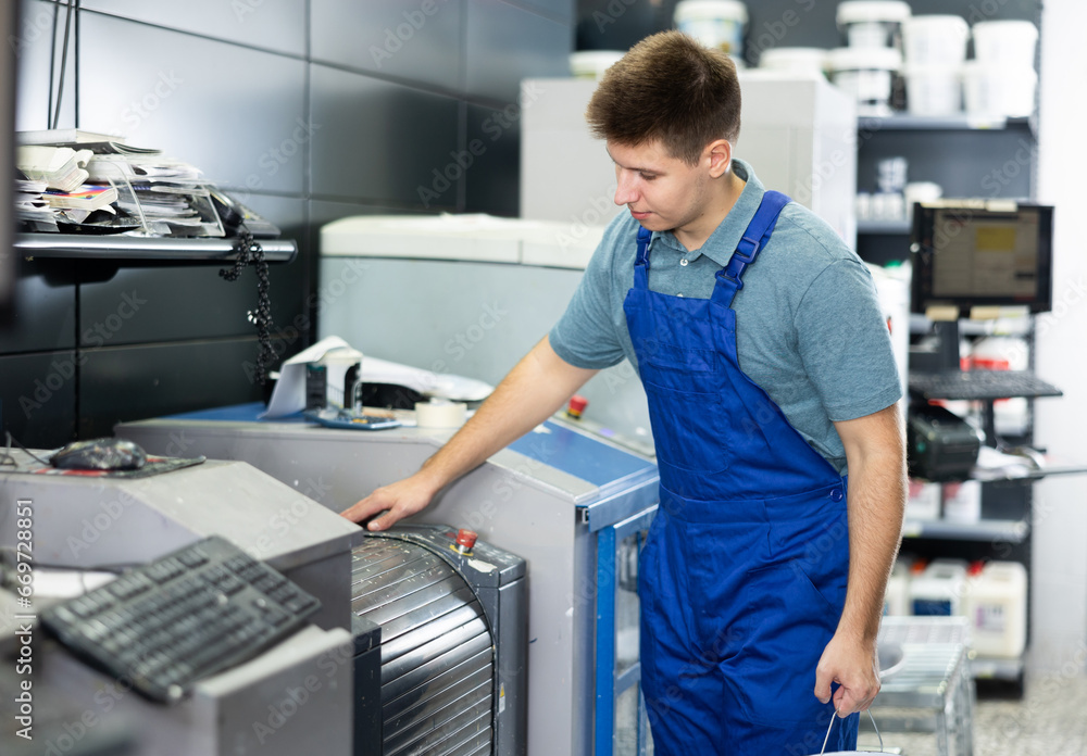 Guy employee of warehouse store construction and repair materials mixes ...